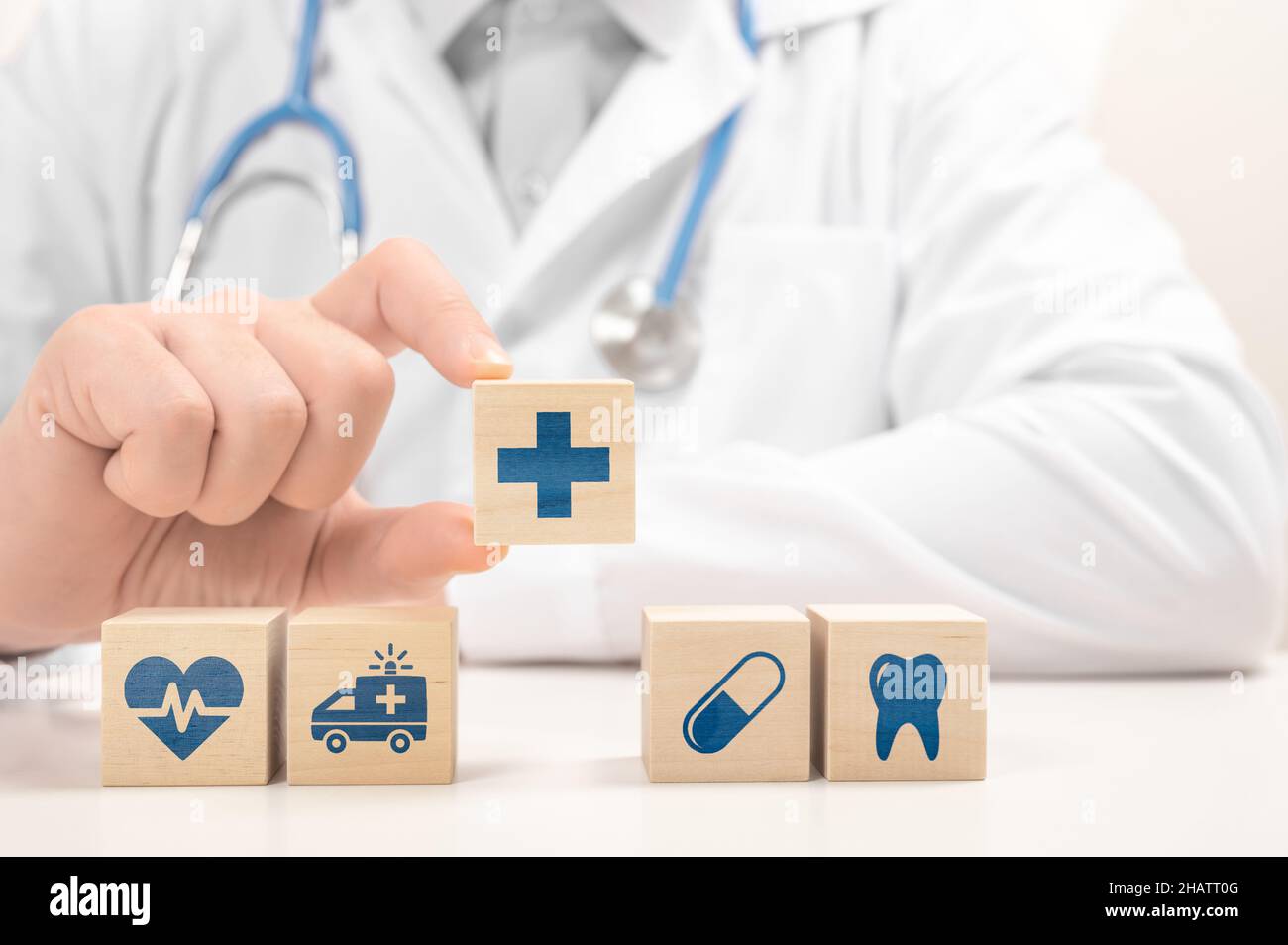 Doctor hand choose cross sign on wood cube block. healthcare medical ...