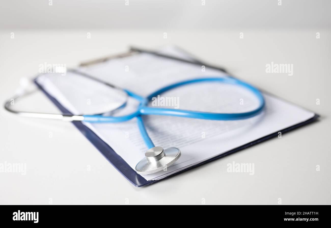 medical journal and stethoscope on white table. Healthcare Benefits ...