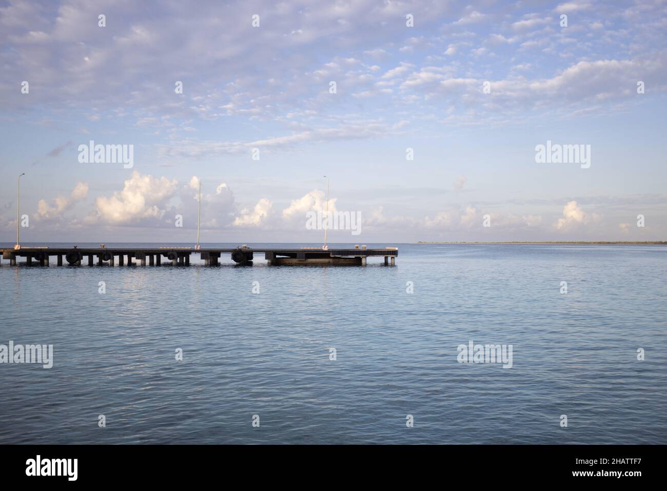 The morning seascape. The pier, the sea and soft clouds above it Stock ...