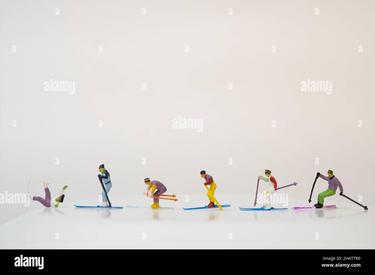Group of miniature figures of skiers on a white background Stock Photo ...