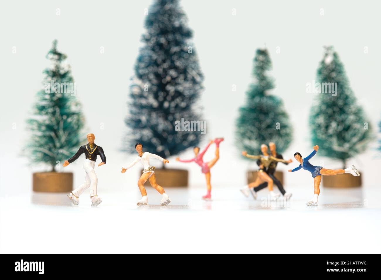Group of miniature figures of ice skaters on a white background Stock ...