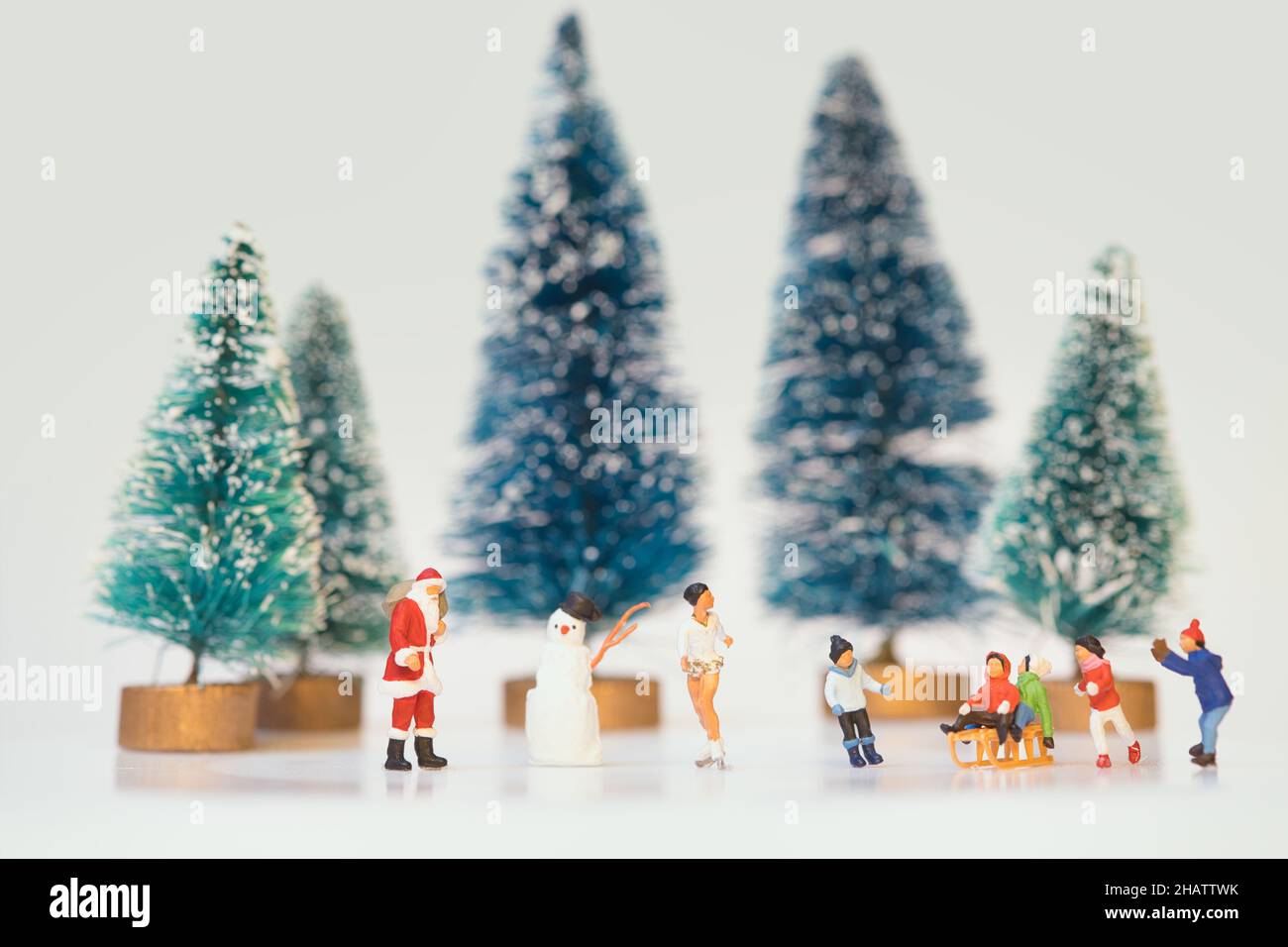 Christmas scene of miniature figures of Santa Claus and kids playing in ...