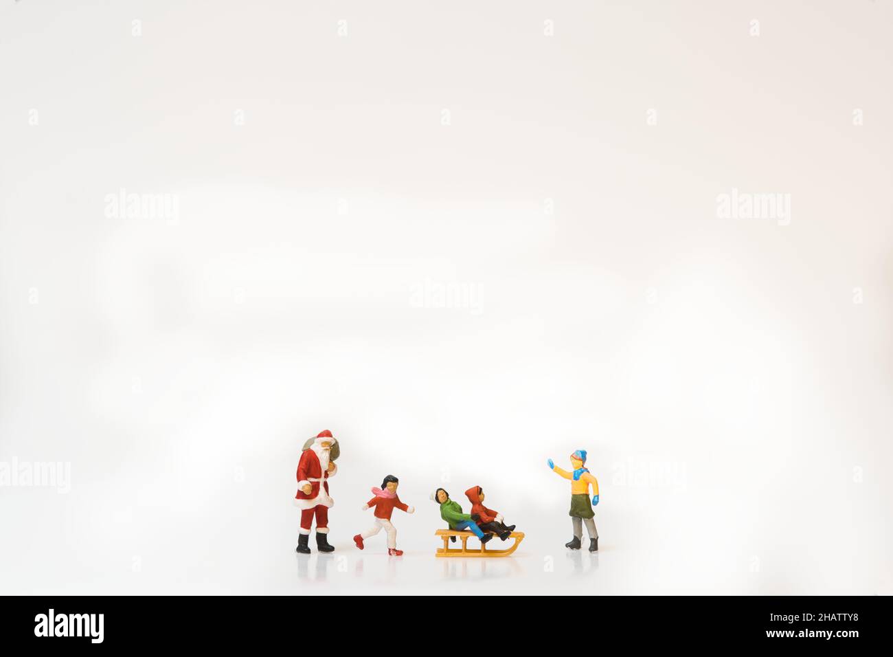 Christmas scene of miniature figures of kids and Santa Claus playing in ...