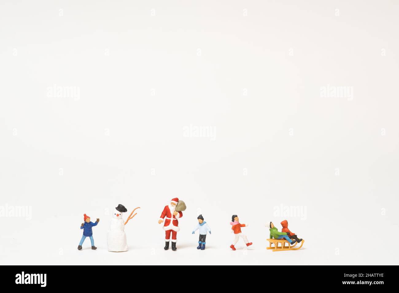 Christmas scene of miniature figures of kids and Santa Claus playing in ...