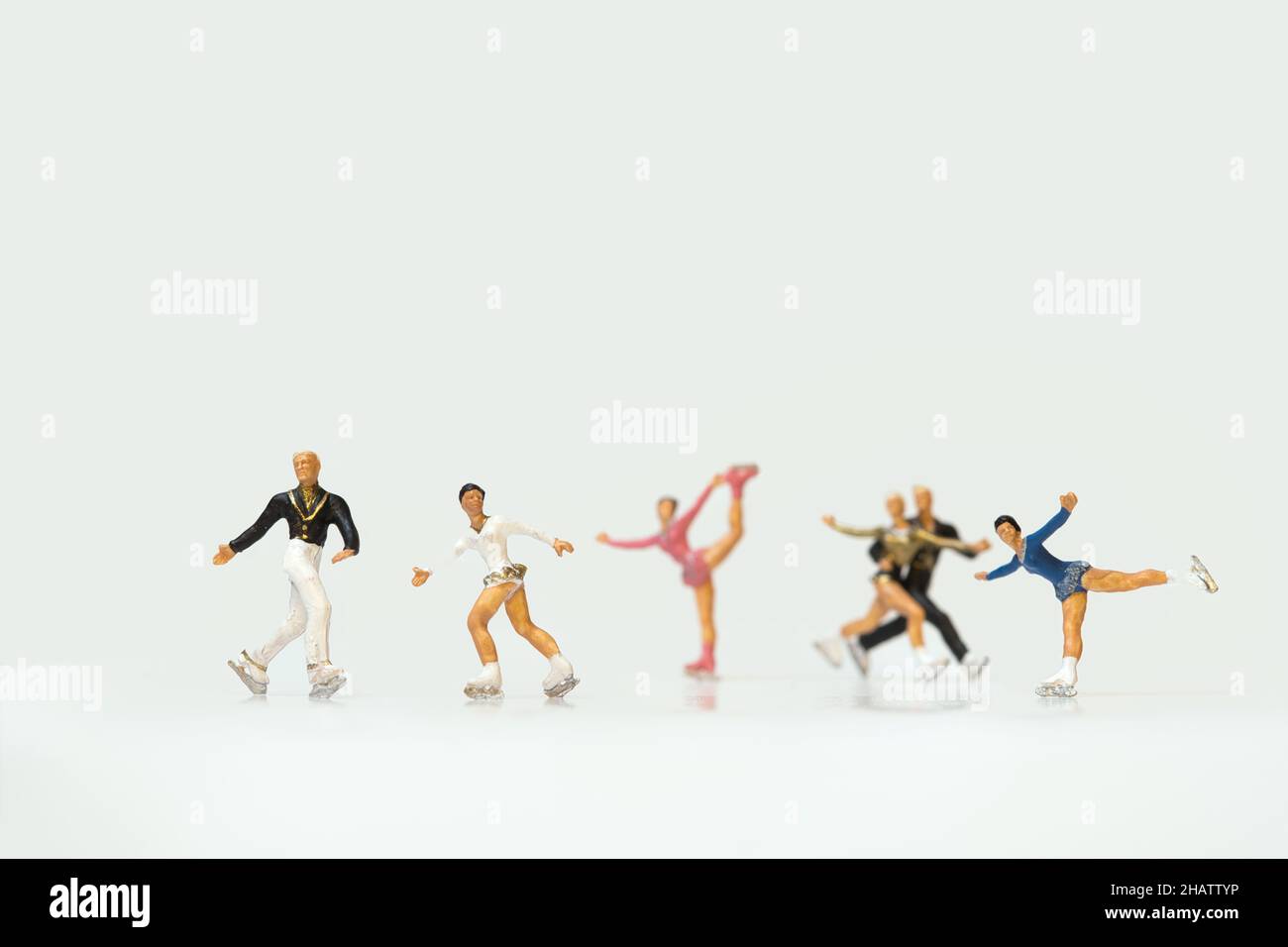 Group of miniature figures of ice skaters on a white background Stock ...