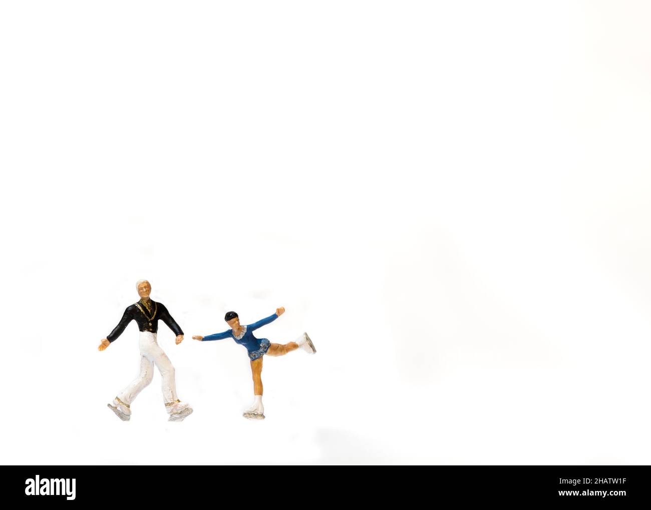 Miniature figures of ice skaters on a white background Stock Photo - Alamy