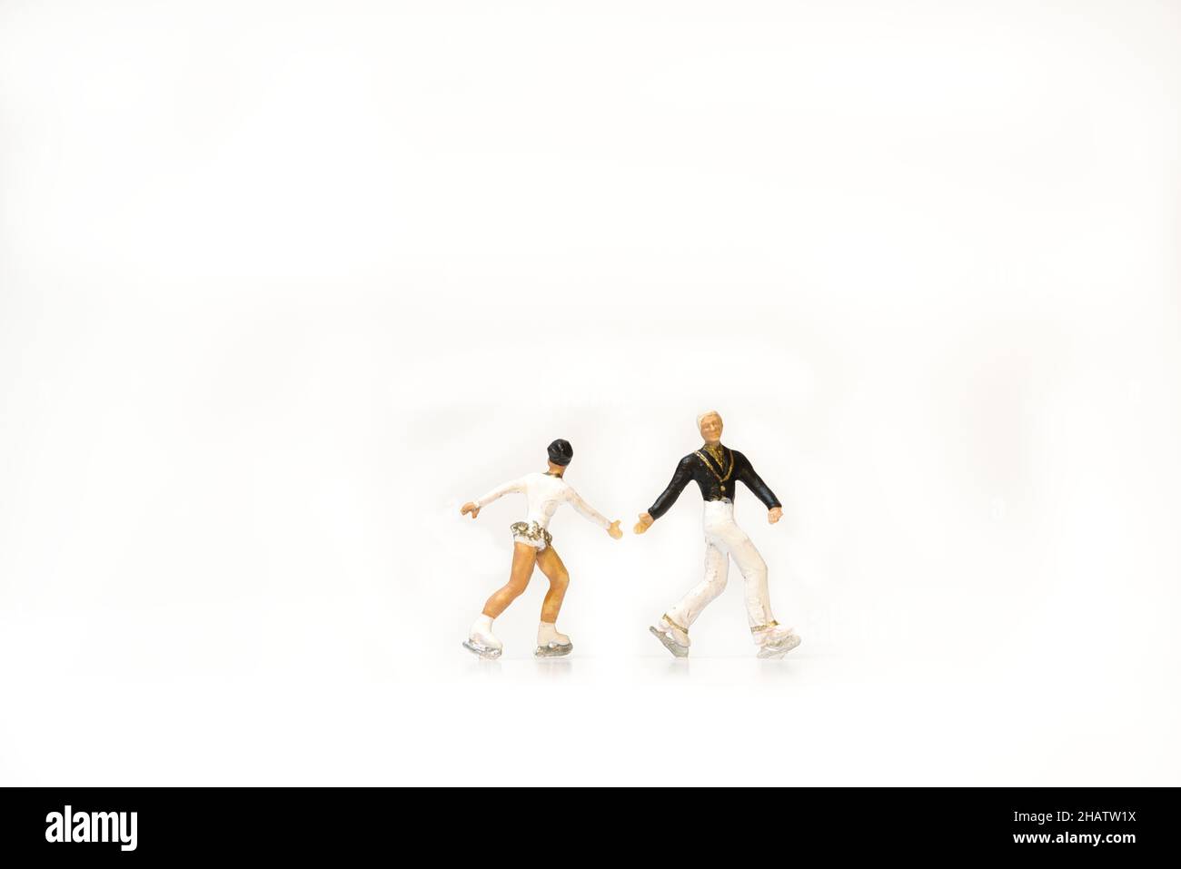 Miniature figures of ice skaters on a white background Stock Photo - Alamy
