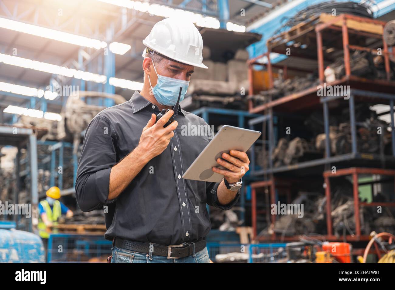 Inspector foreman wearing face mask or engineer manager looking at ...