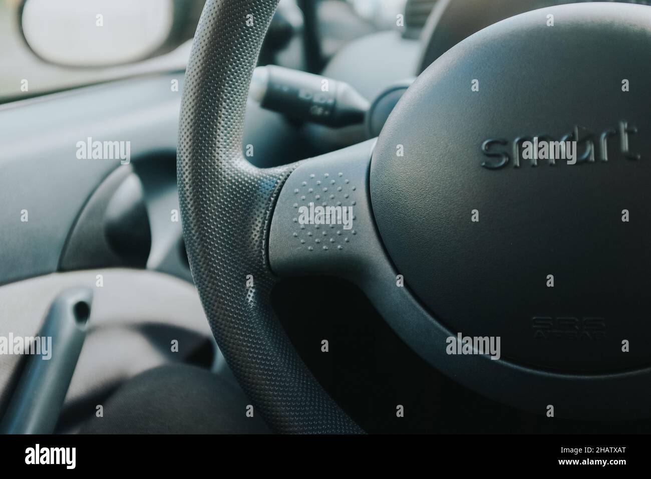 Smart sign on the steering wheel of the car Stock Photo - Alamy