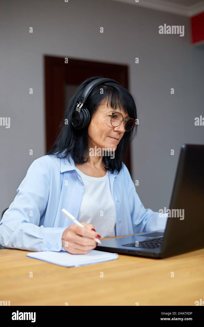Senior woman student learning language, watching online course, e ...