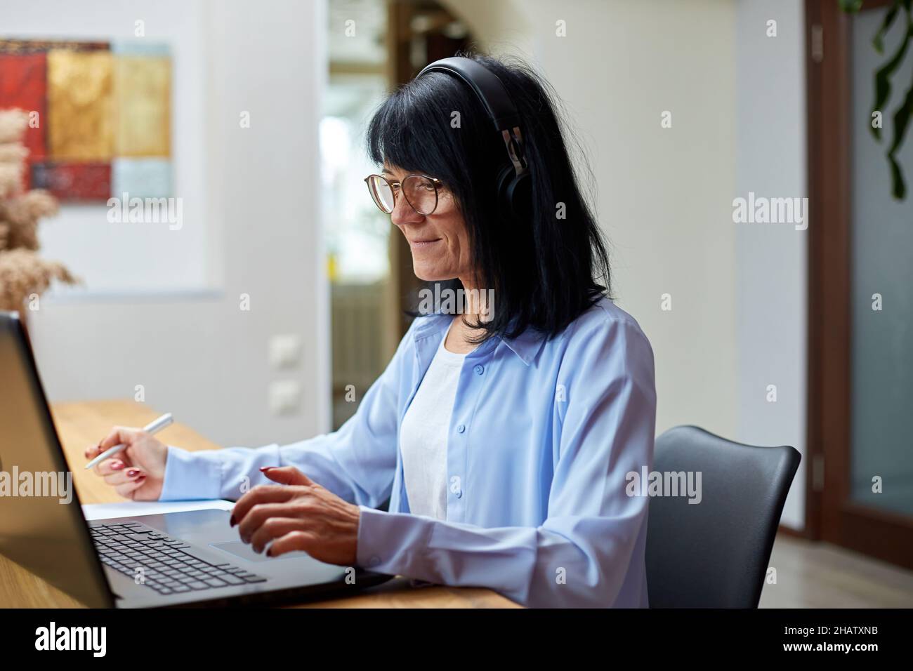 Senior woman student learning language, watching online course, e ...
