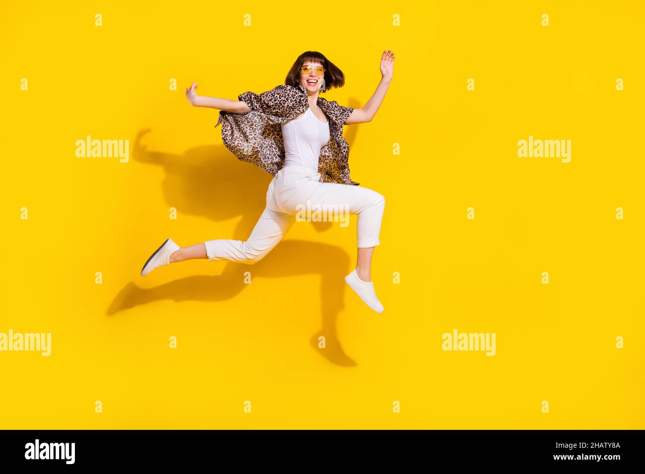 Full length body size view of attractive sporty cheerful girl jumping ...