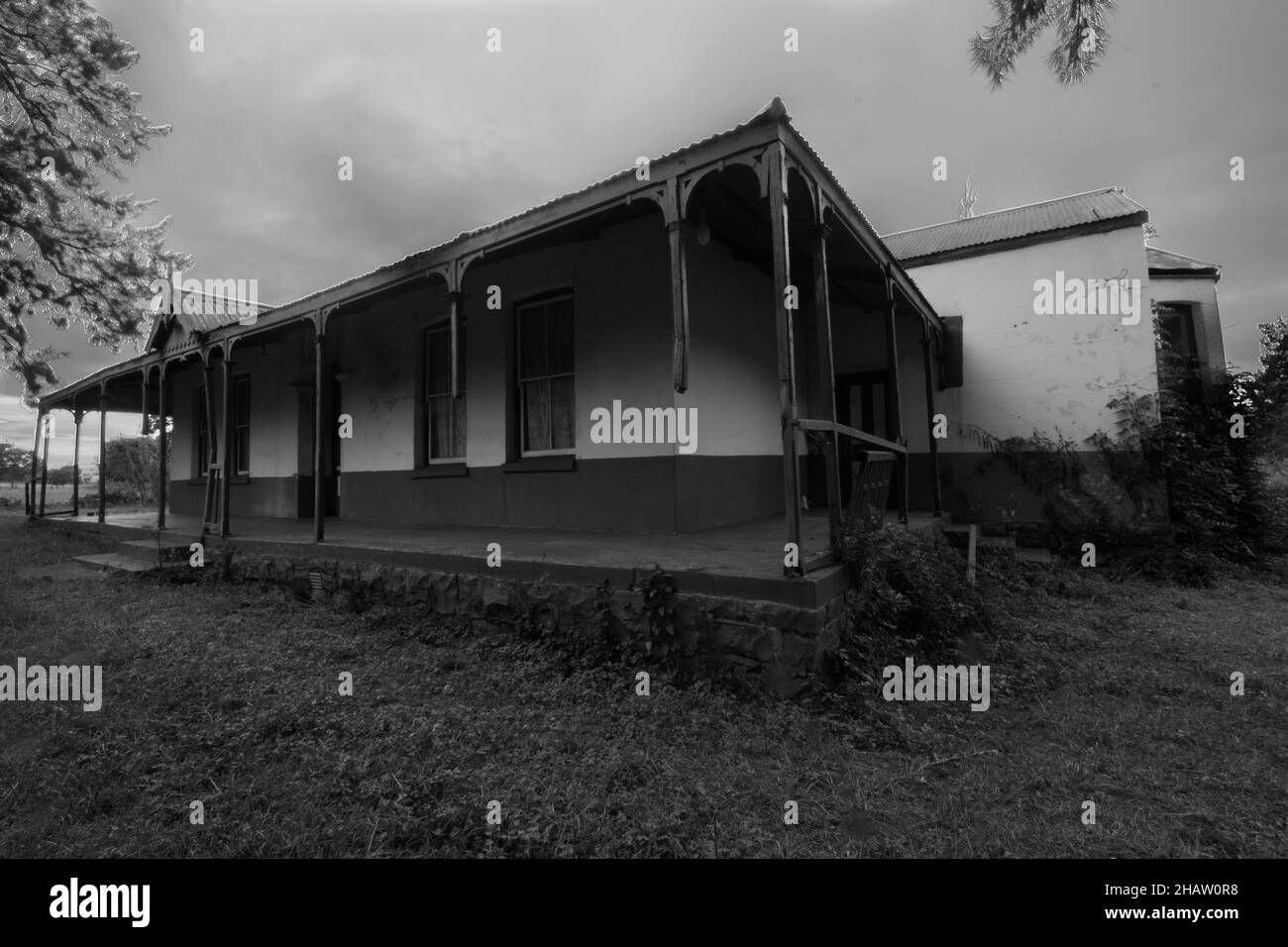 Grayscale of an old farmhouse with wooden windows Stock Photo - Alamy