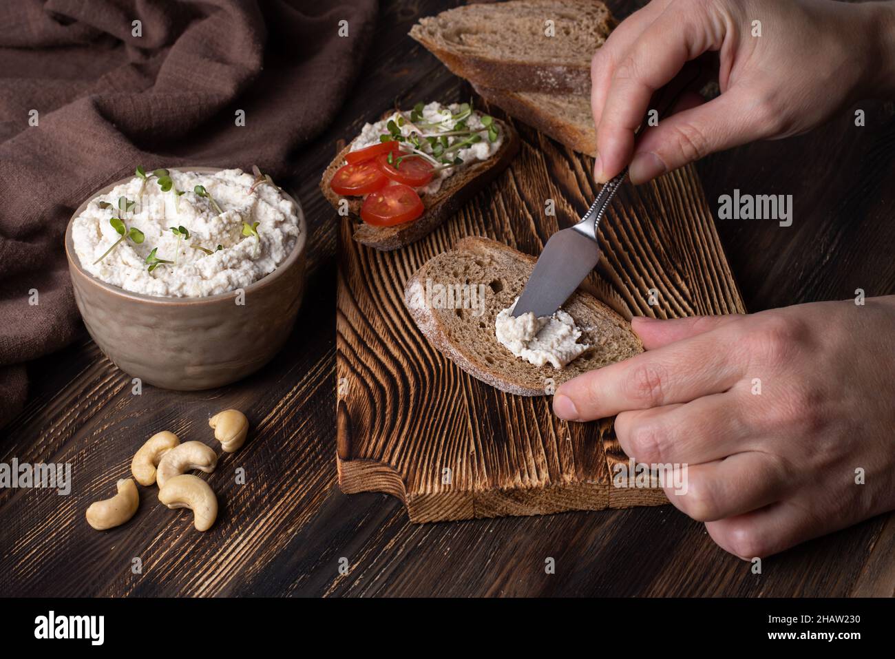 Fermented foods for healthy eating, female hands spreading vegan cashew ...