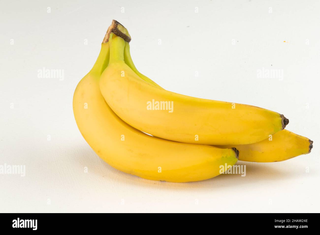 Three bananas on white background Stock Photo - Alamy