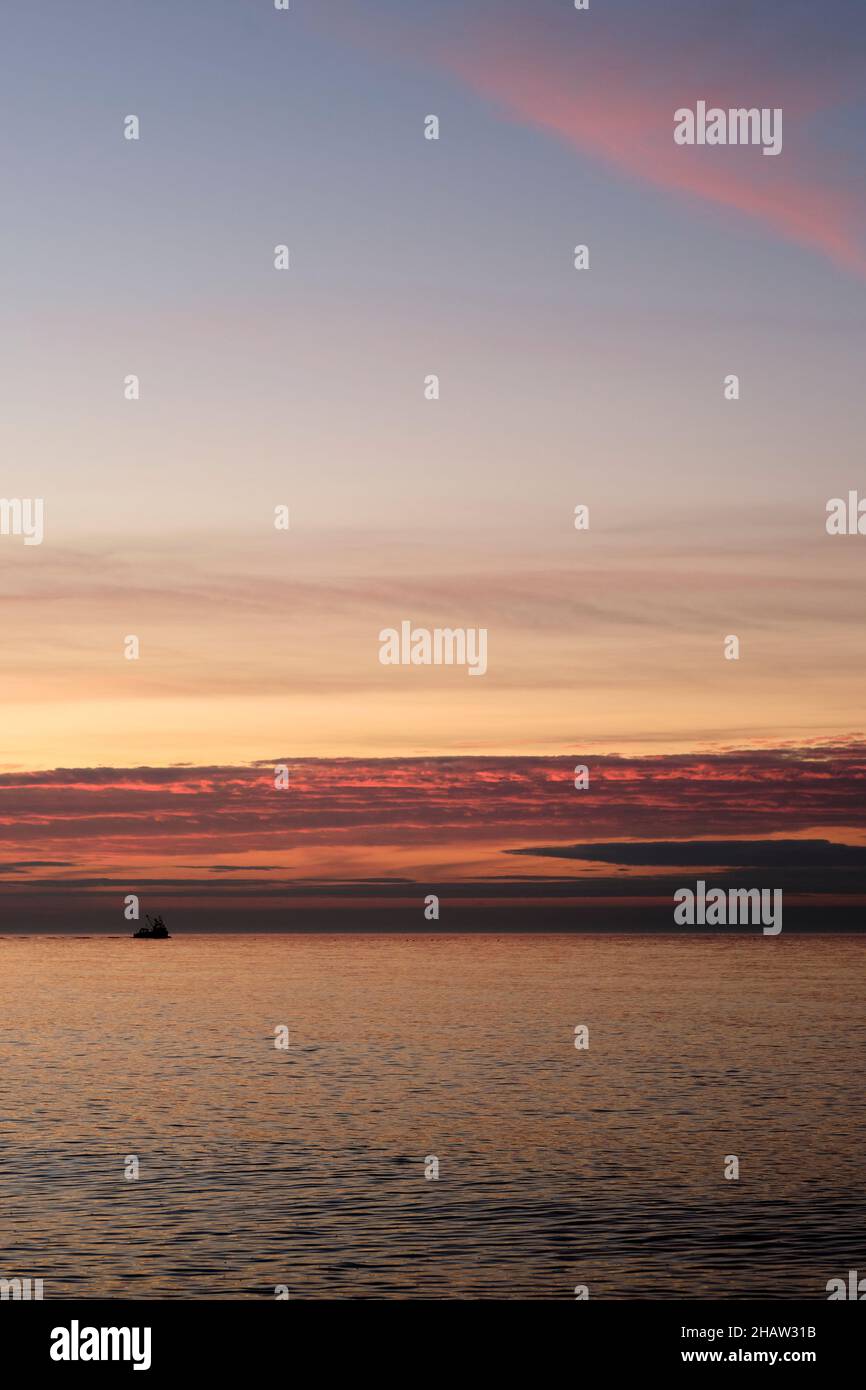A fishing boat head out to sea from Kings Lynn to an early winter ...