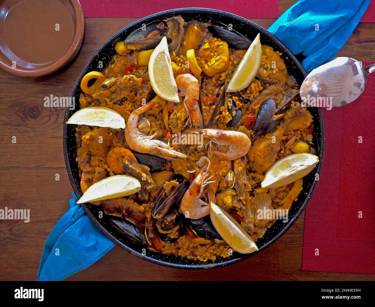 Typical paella pan on wooden table, Spanish rice dish, pan dish, paella ...