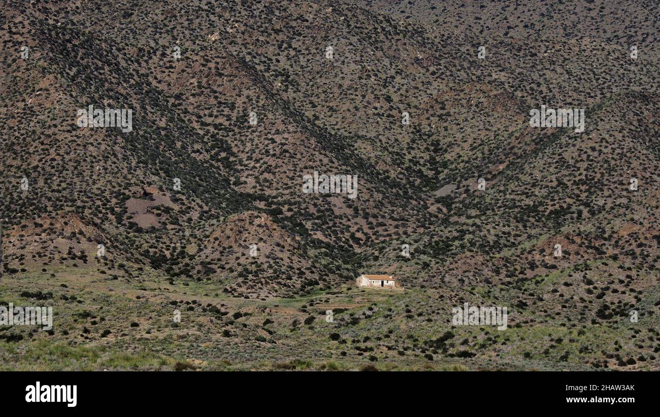Lonely small finca surrounded by hills, abandoned house in barren ...