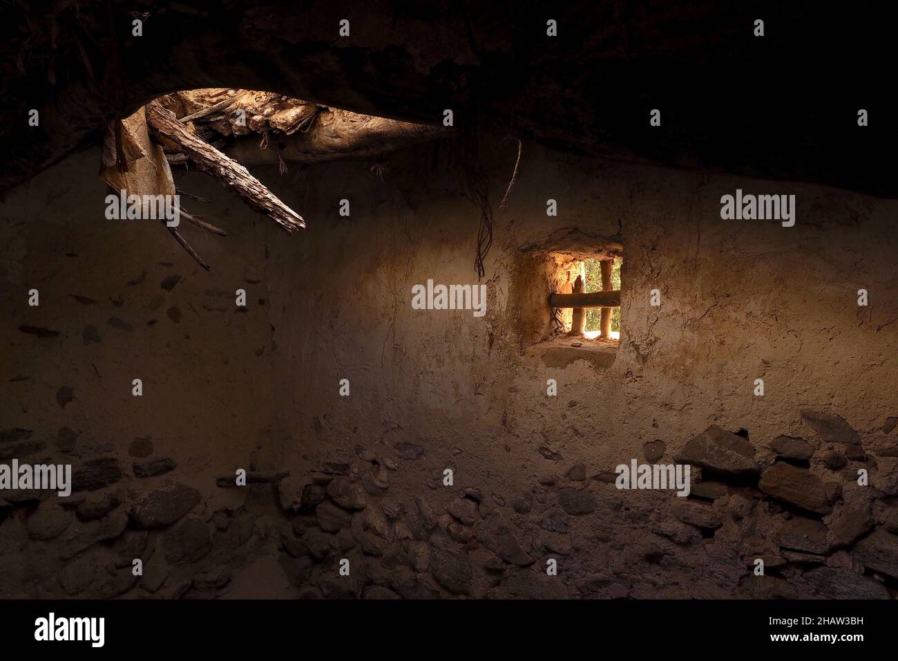 Old stable with collapsed ceiling and wooden lattice window, ruin with ...