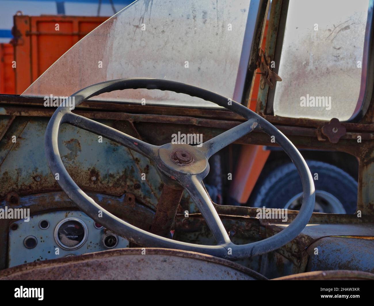 Handlebar and broken window of old truck, rusty steering pane of truck ...