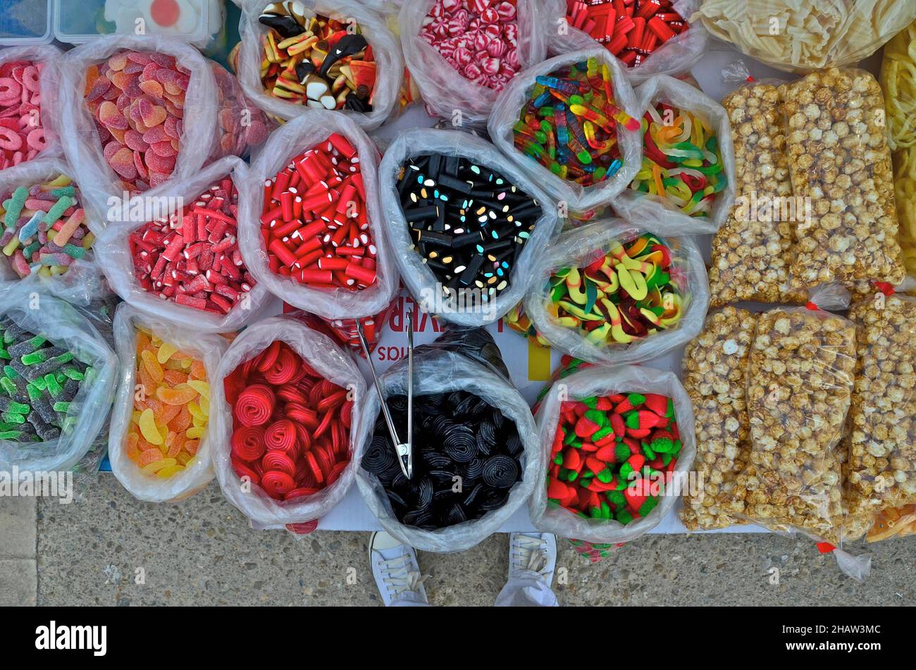 Plastic bags with sweets on market, liquorice snails, fruit gums and ...
