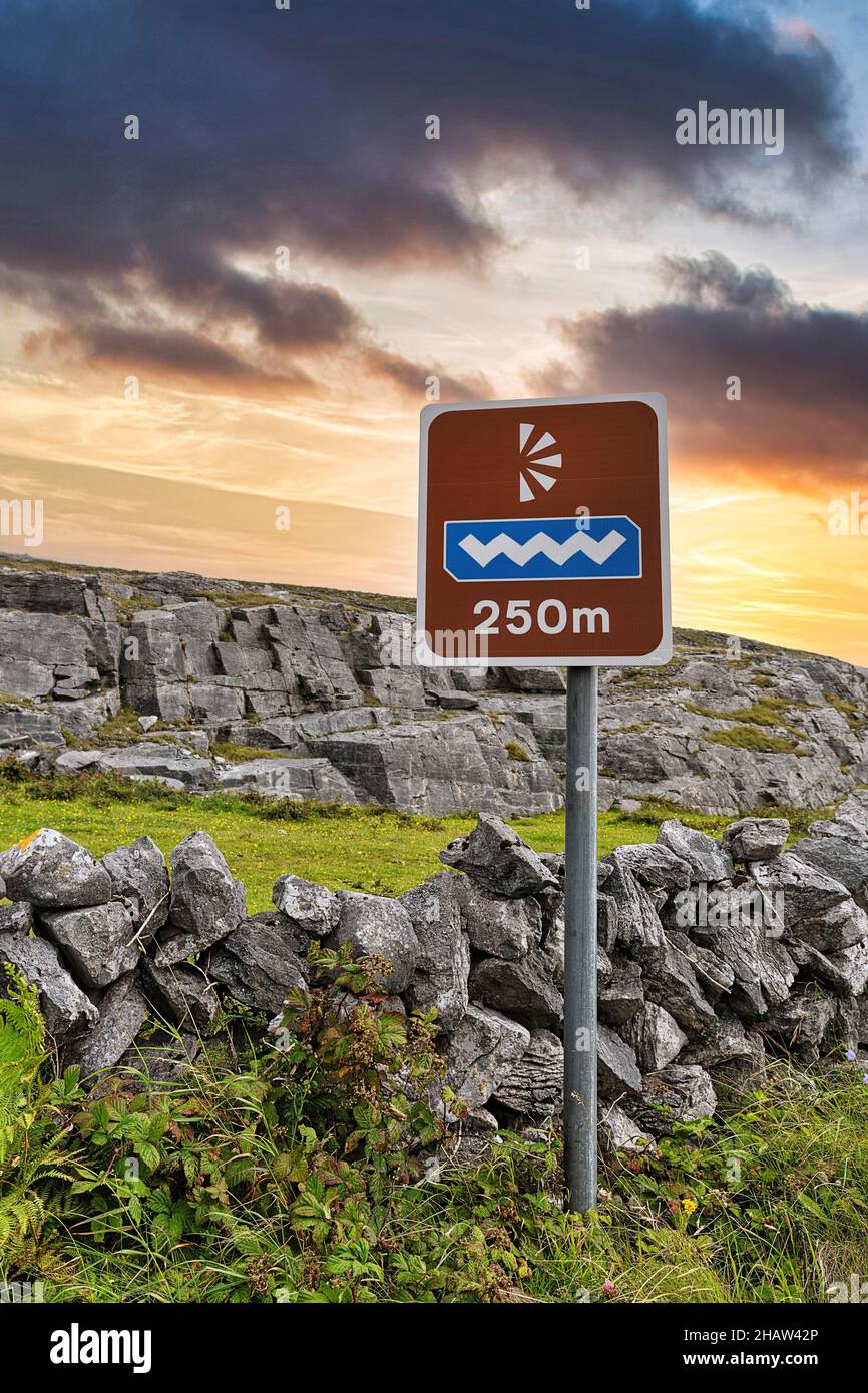 Wavy logo on a sign marks viewpoint in karst landscape, Irish coastal ...