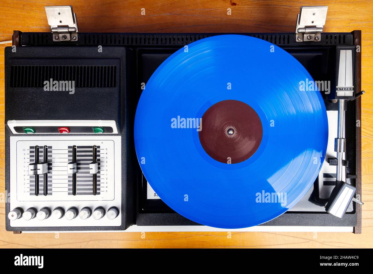 Vintage turntable vinyl record player with blue vinyl on a table Stock ...