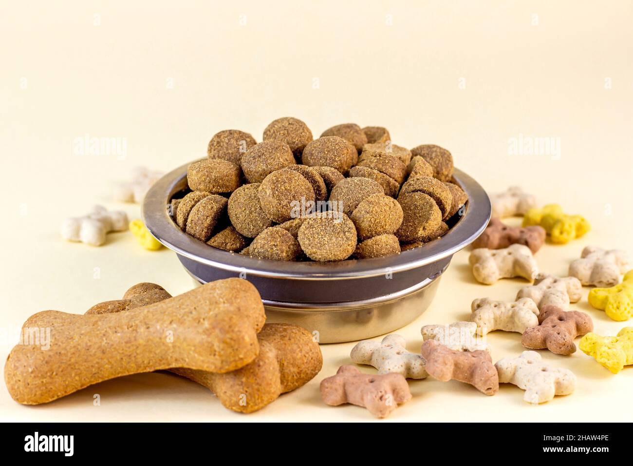 Brown biscuit bones and crunchy organic kibble pieces for dog feed on ...