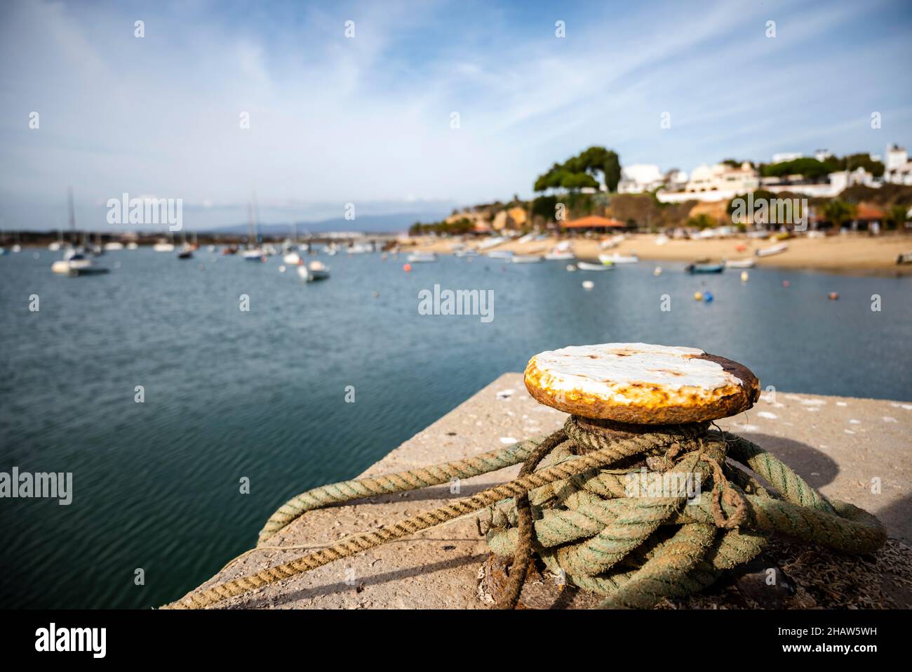 View of fishermen's line harbored in the port of Alvor with cityscape ...