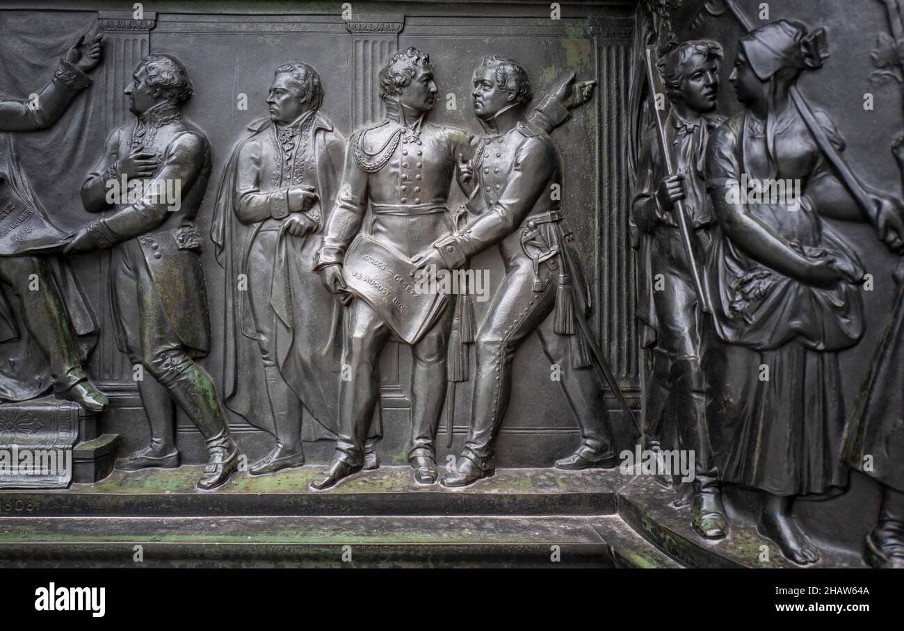 Bronze figures at the base of the monument to Frederick the Great Unter ...