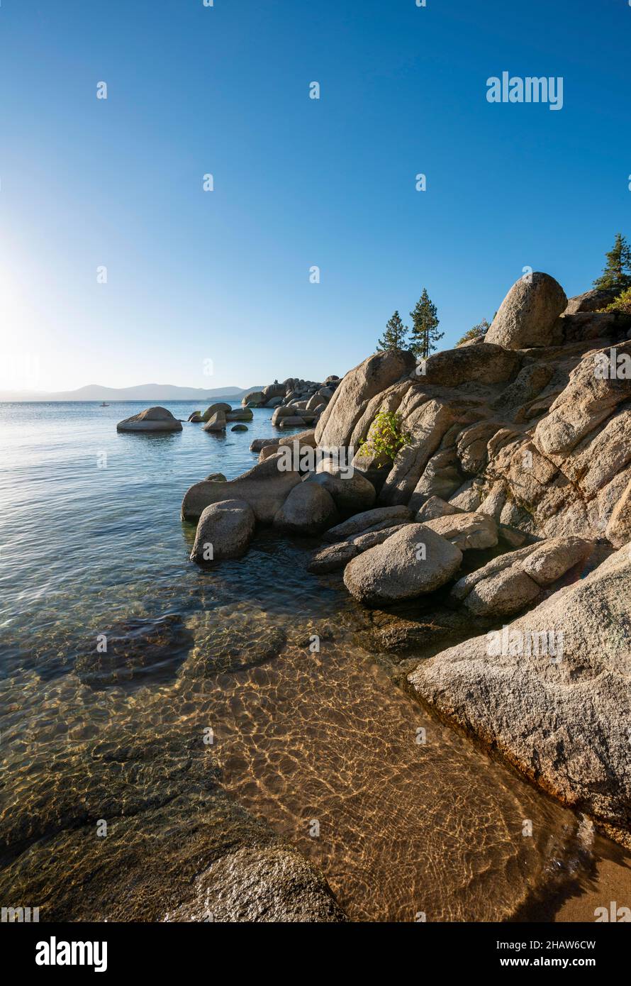 Sand beach and round stones in the water, bay at Lake Tahoe, Sand ...