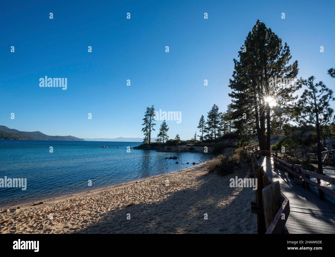 Wooden walkway on sandy beach with sun star, bay on Lake Tahoe, Sand ...