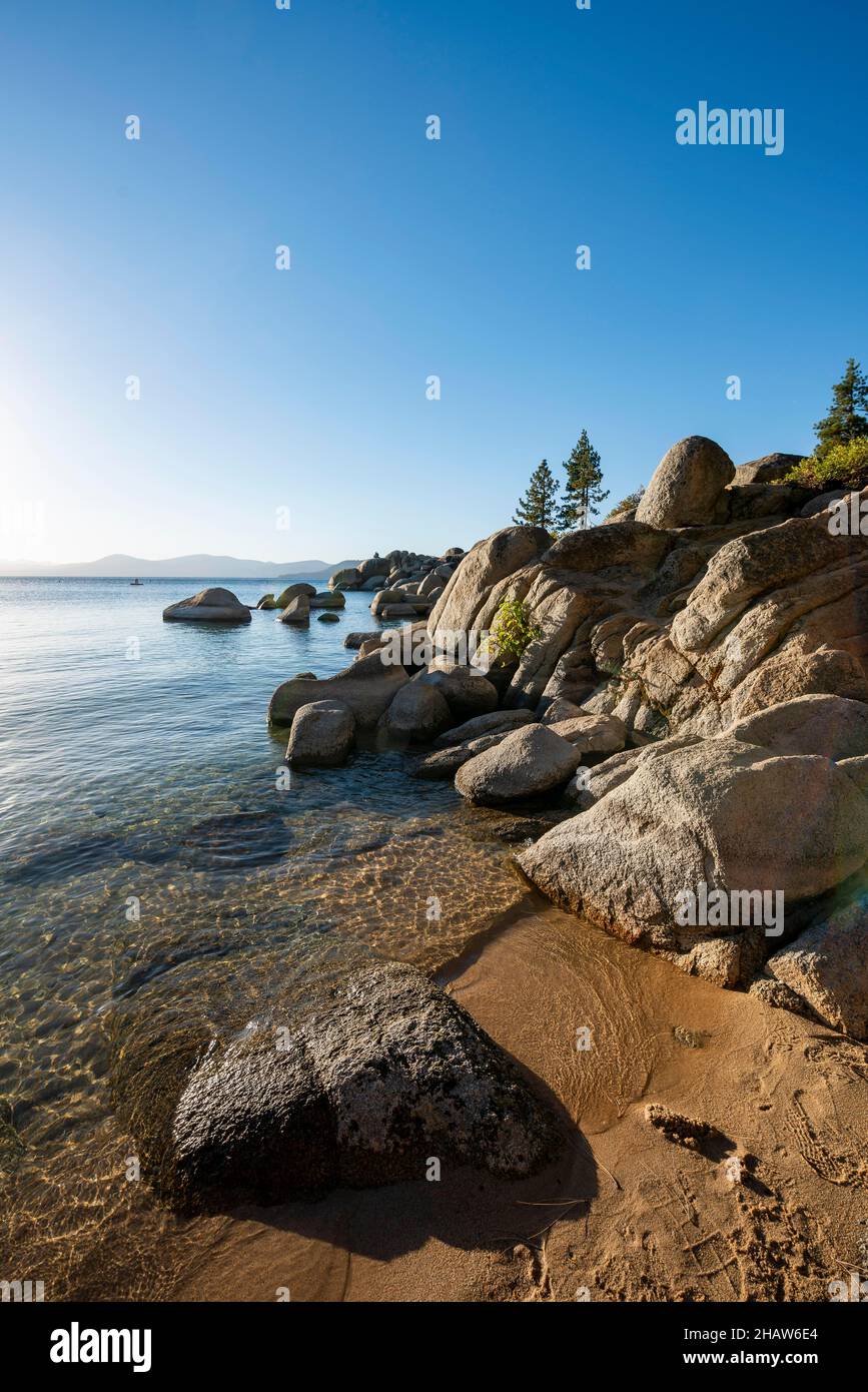 Sand beach and round stones in the water, bay at Lake Tahoe, Sand ...