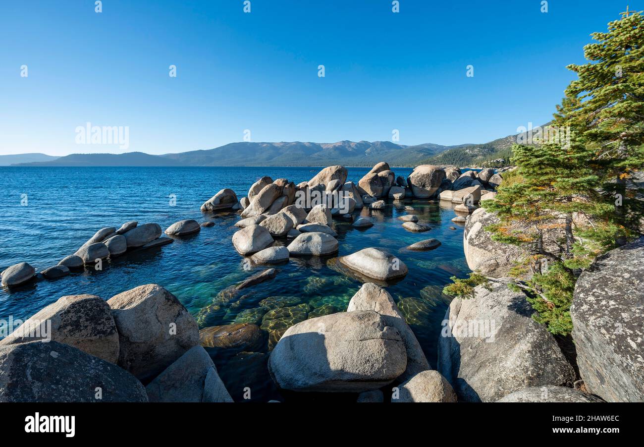 Lake Tahoe shore with round stones in the water, Sand Harbor Beach, in ...