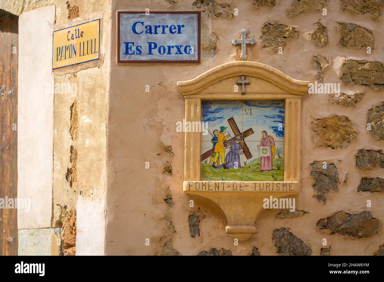 Road sign and Station of the Cross, Deia village, Majorca, Spain Stock ...