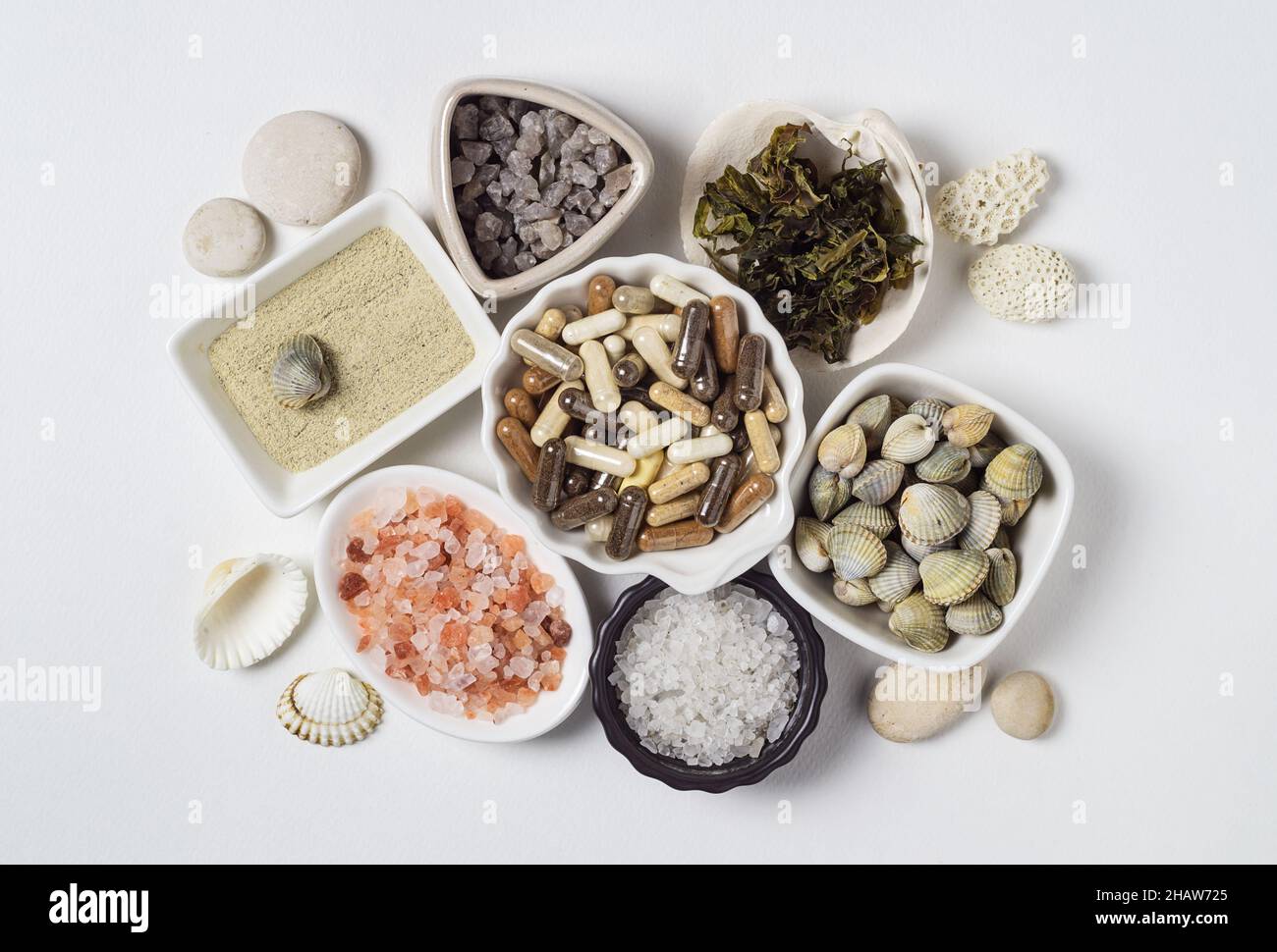 Dietary supplements in capsules, various crystals of salt, algae and ...