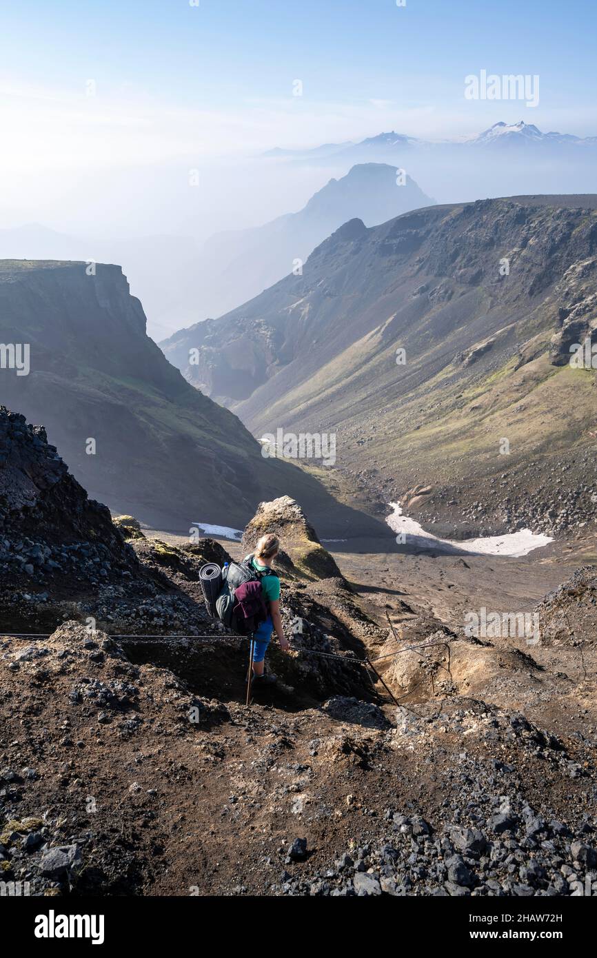 Hiker on the Fimmvoerouhals hiking trail, barren volcanic landscape ...
