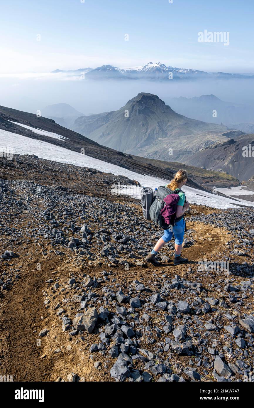 Hiker on the Fimmvoerouhals hiking trail, barren volcanic landscape ...