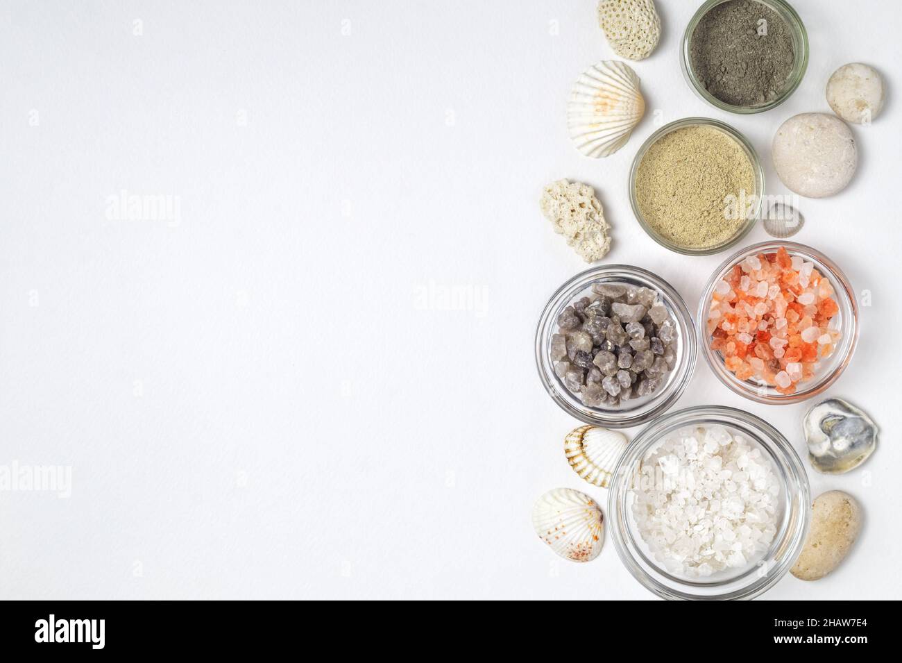 Various types of salt crystals, powder of sea minerals in glass bowls ...