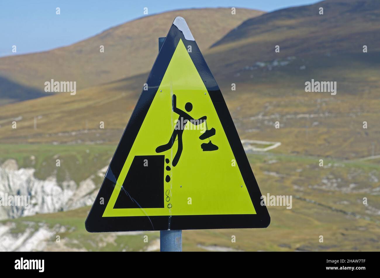 Warning sign with figure falling down, cliffs, Achill Island, Ireland ...