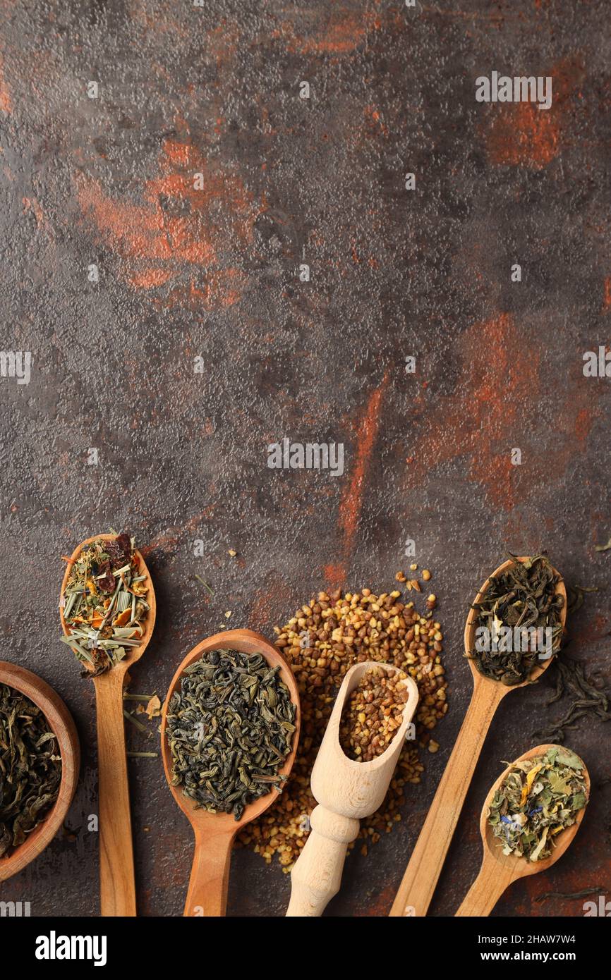 Concept of cooking tea with different types of tea on dark textured ...