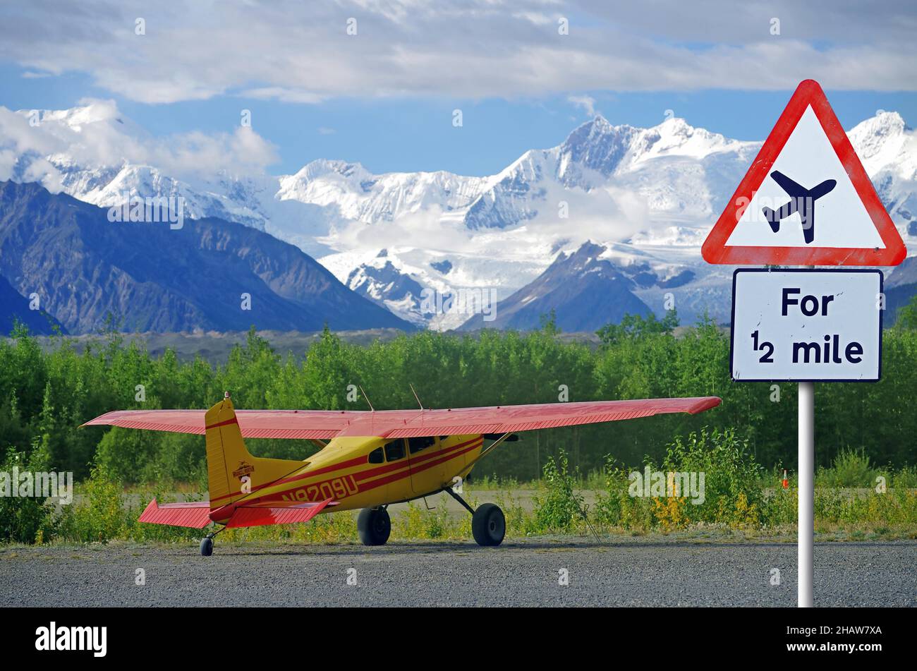Traffic sign warning of aircraft, small plane in the mountains, glacier ...
