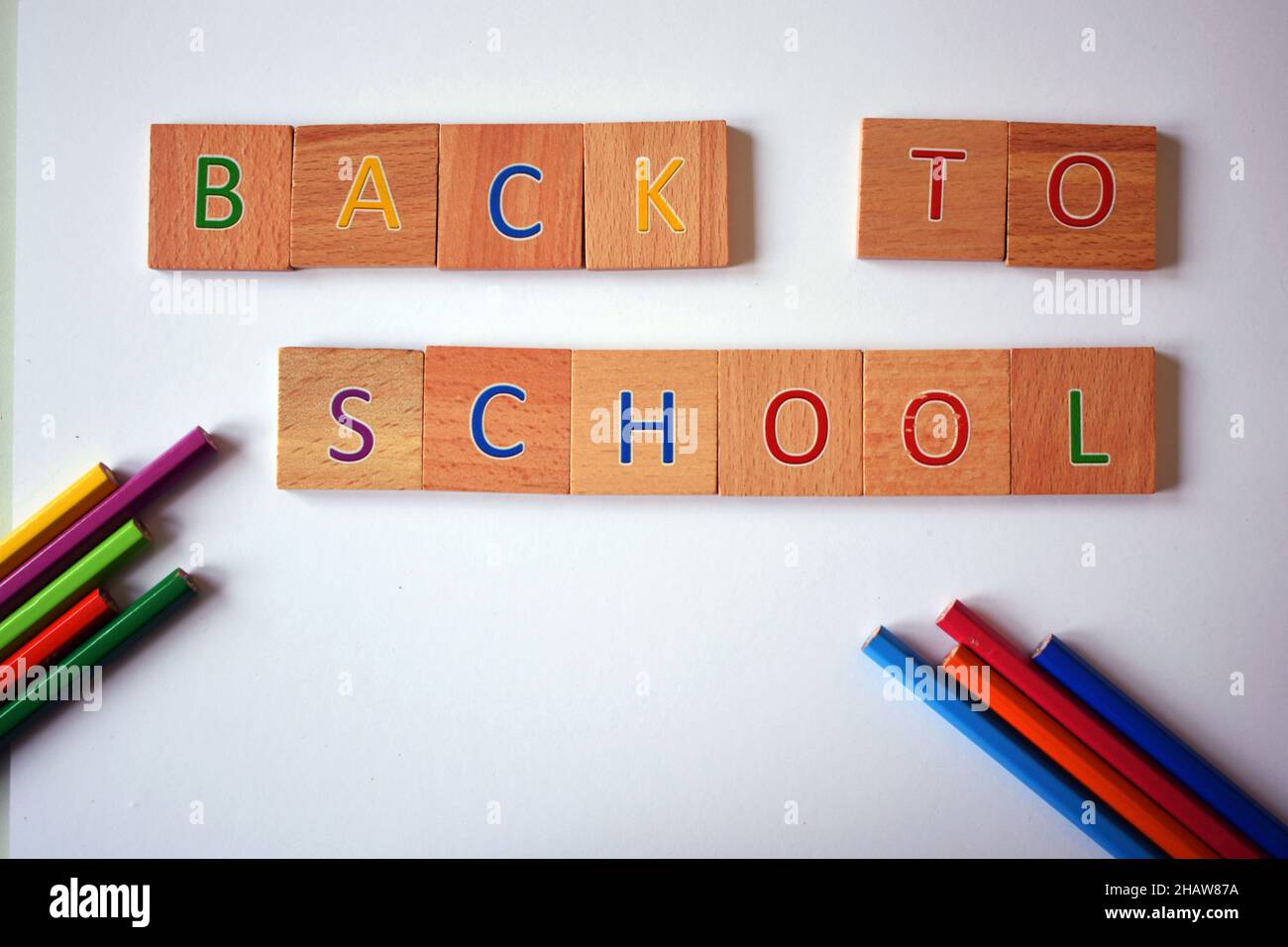 Closeup of the wooden blocks with letters and colored pencils. Back to ...