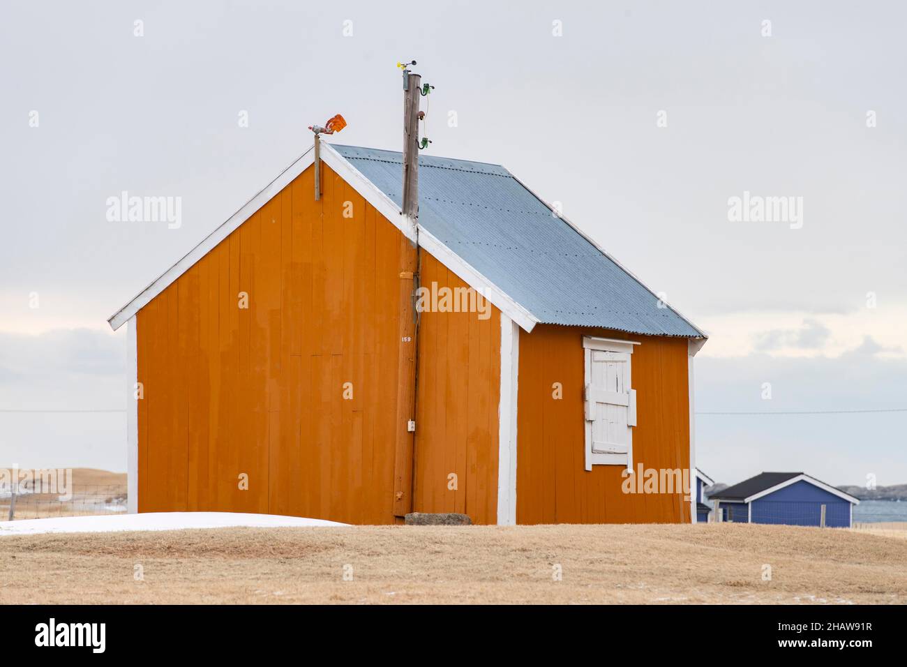 Scandinavian house in winter landscape, mountains, snow, fjord, sea ...