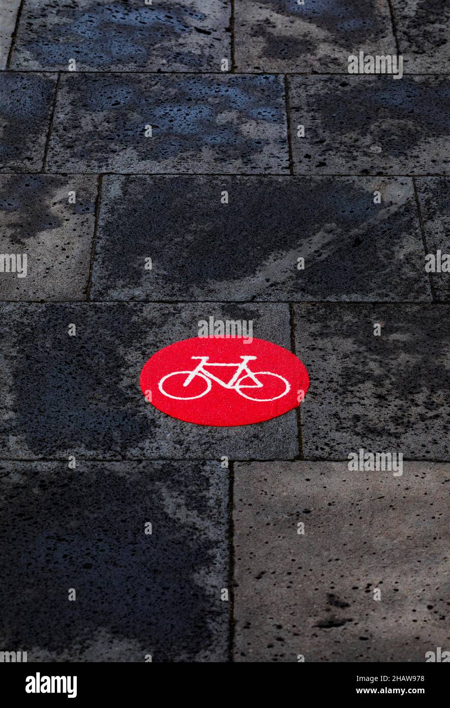 Red cycle path marking on wet pavement, Ribeira Grande, Sao Miguel ...