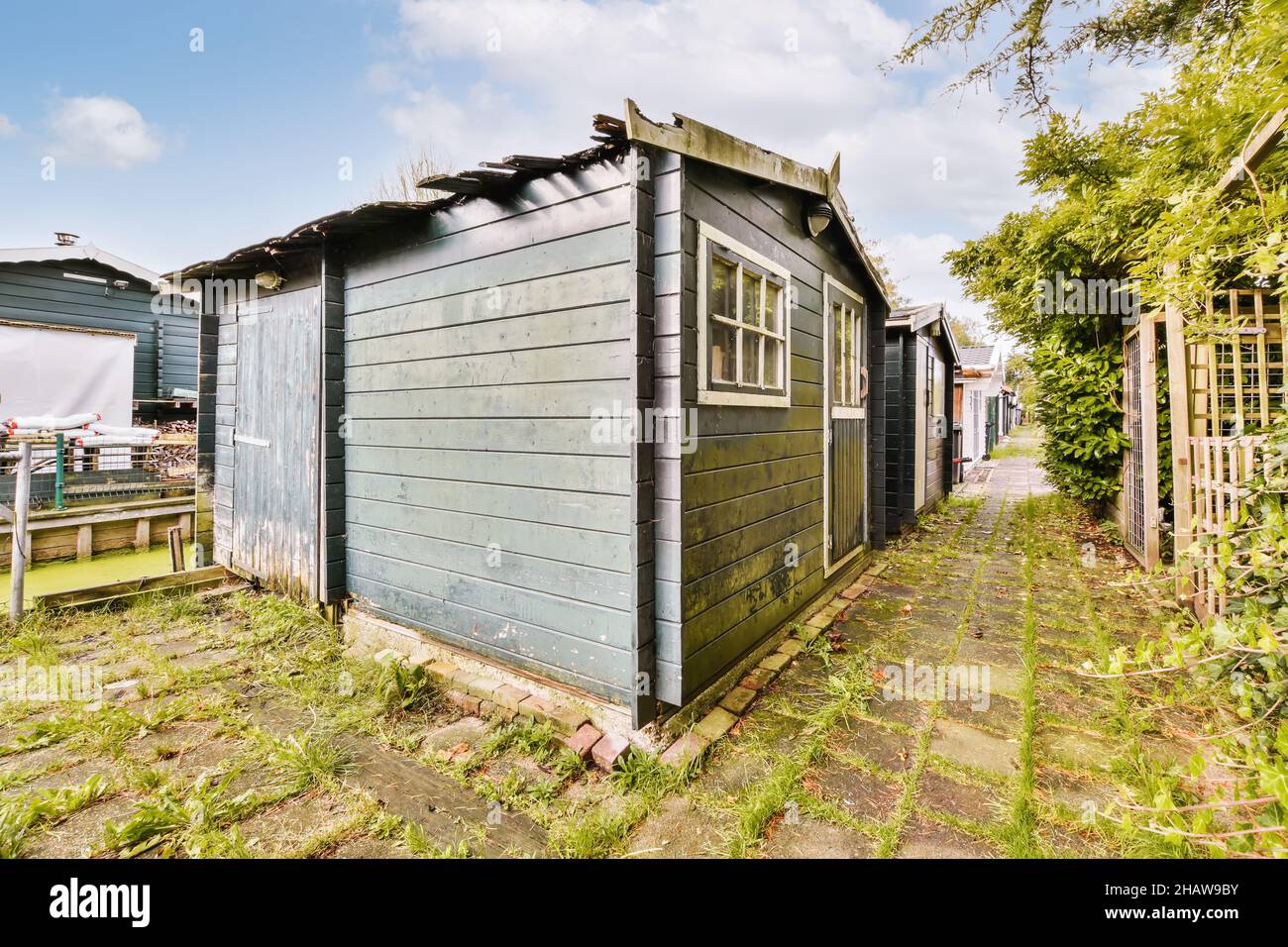 Adorable little black house in the yard Stock Photo - Alamy