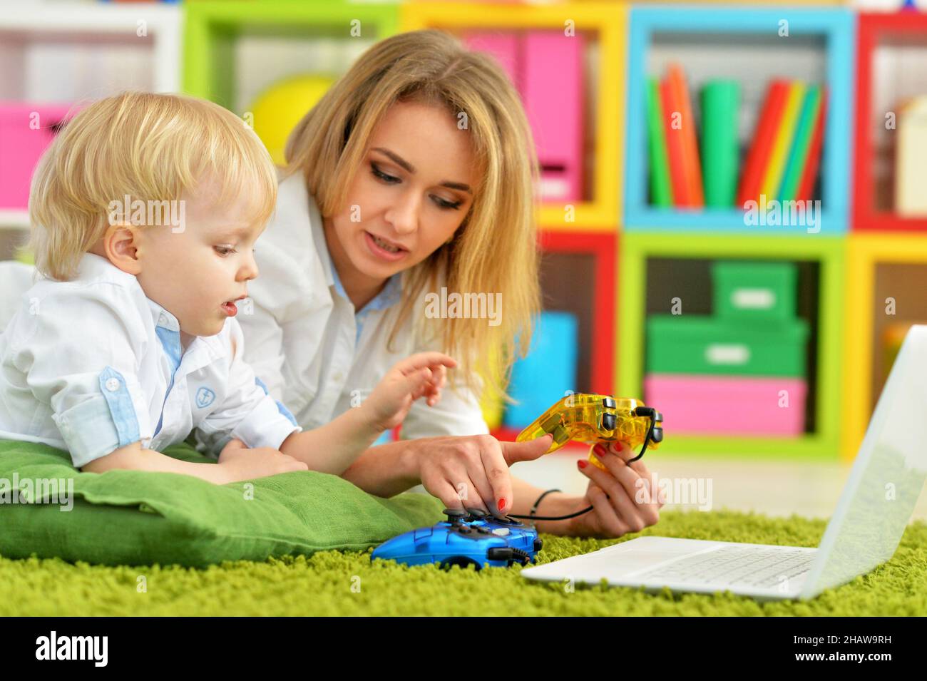 Mother and son playing computer game with laptop Stock Photo - Alamy