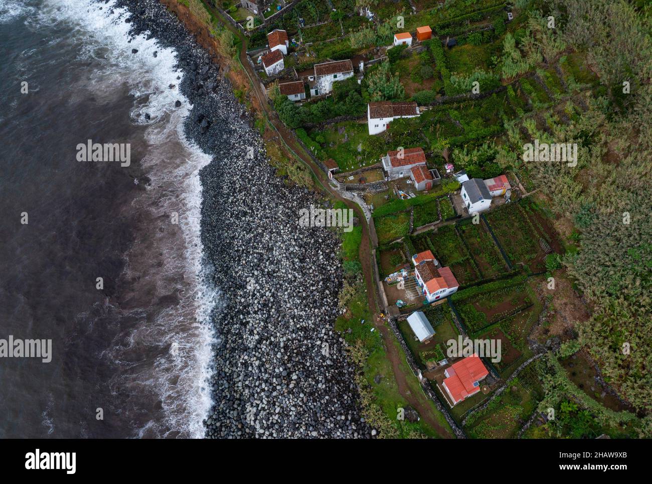 Drone shot, surf with big round stones on the beach of Rocha da Relva ...