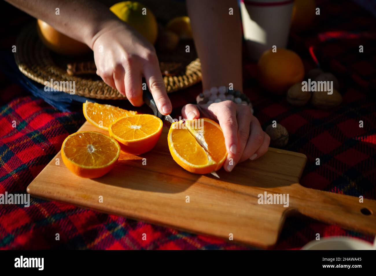 Hand cutting orange hi-res stock photography and images - Alamy
