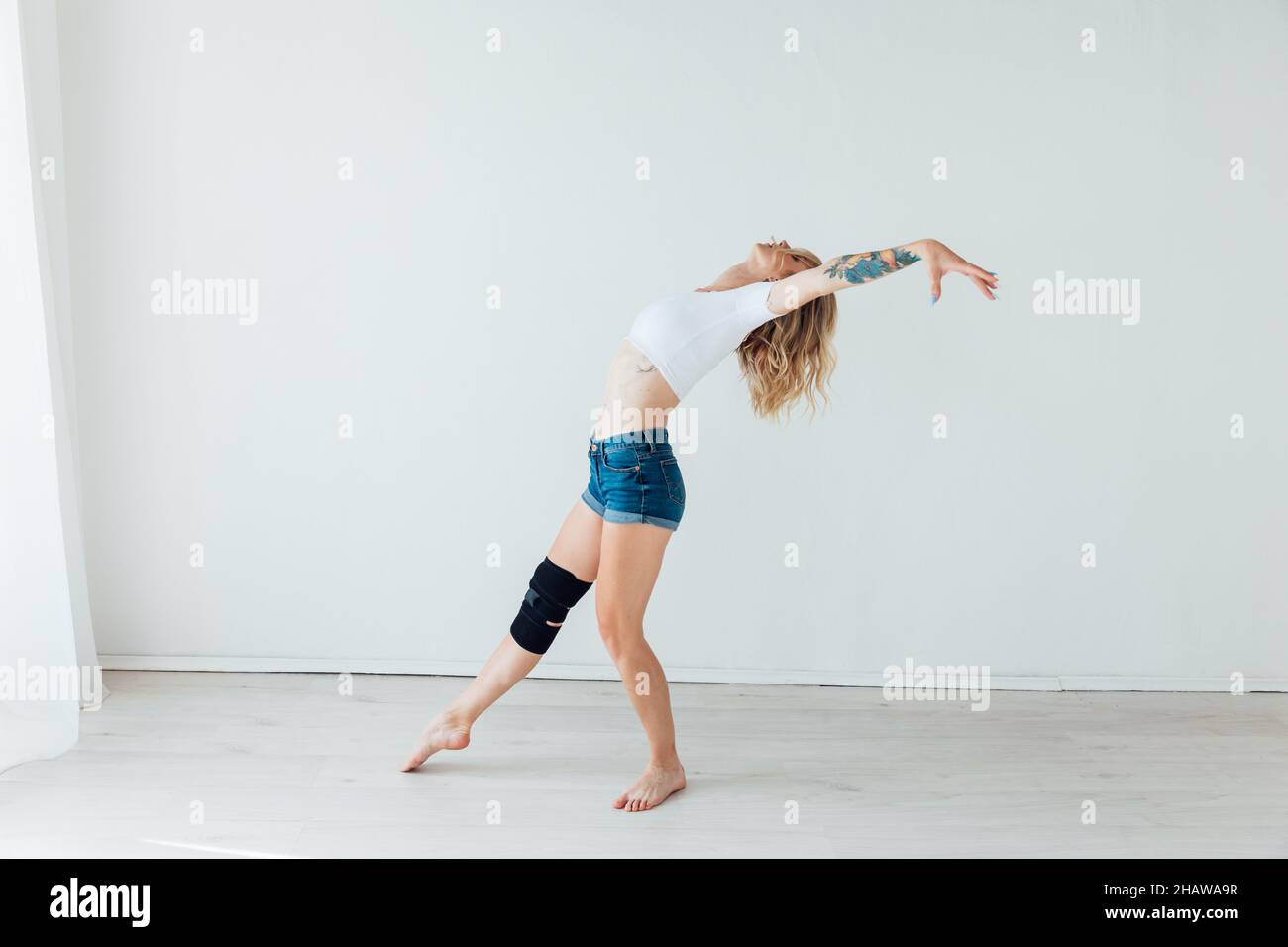 beautiful slender woman dancing to music in a white hall Stock Photo ...